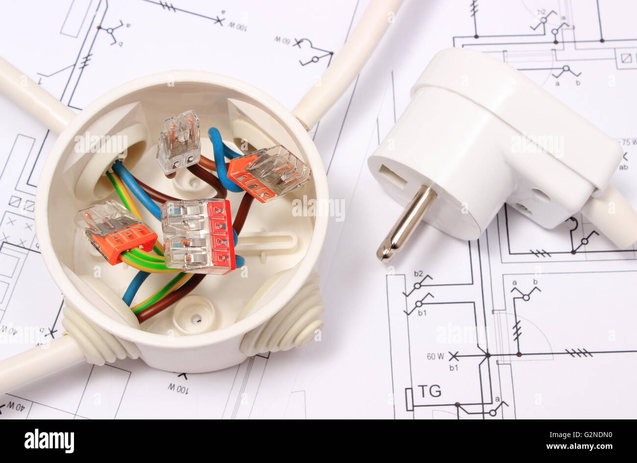 Copper wire connections in electrical box and electric plug lying on ...