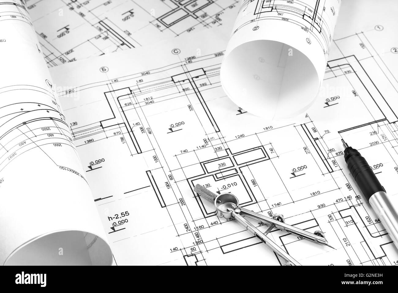 Architectural background with rolls of technical drawings and work ...
