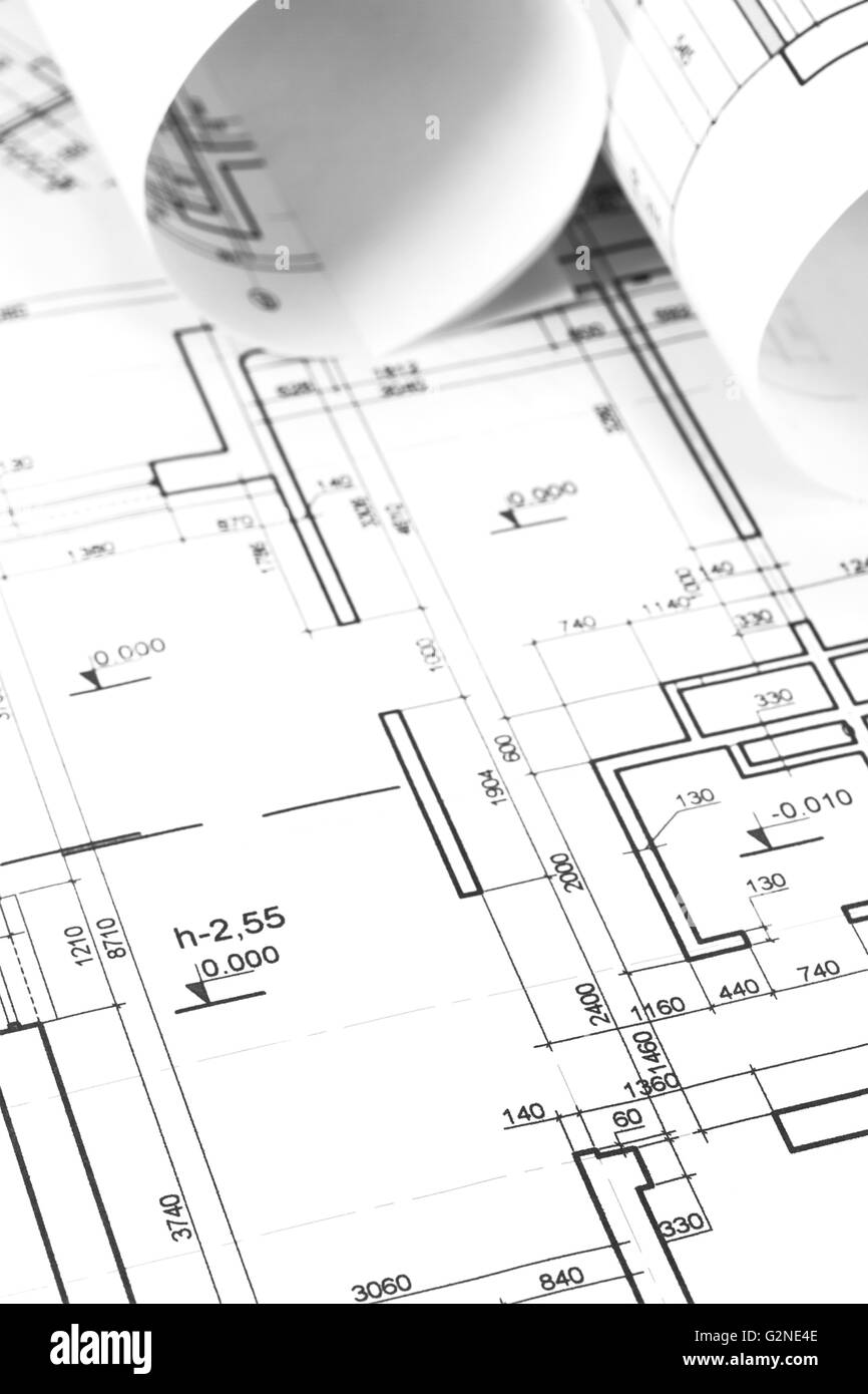 Architectural background with rolls of technical drawings and work ...