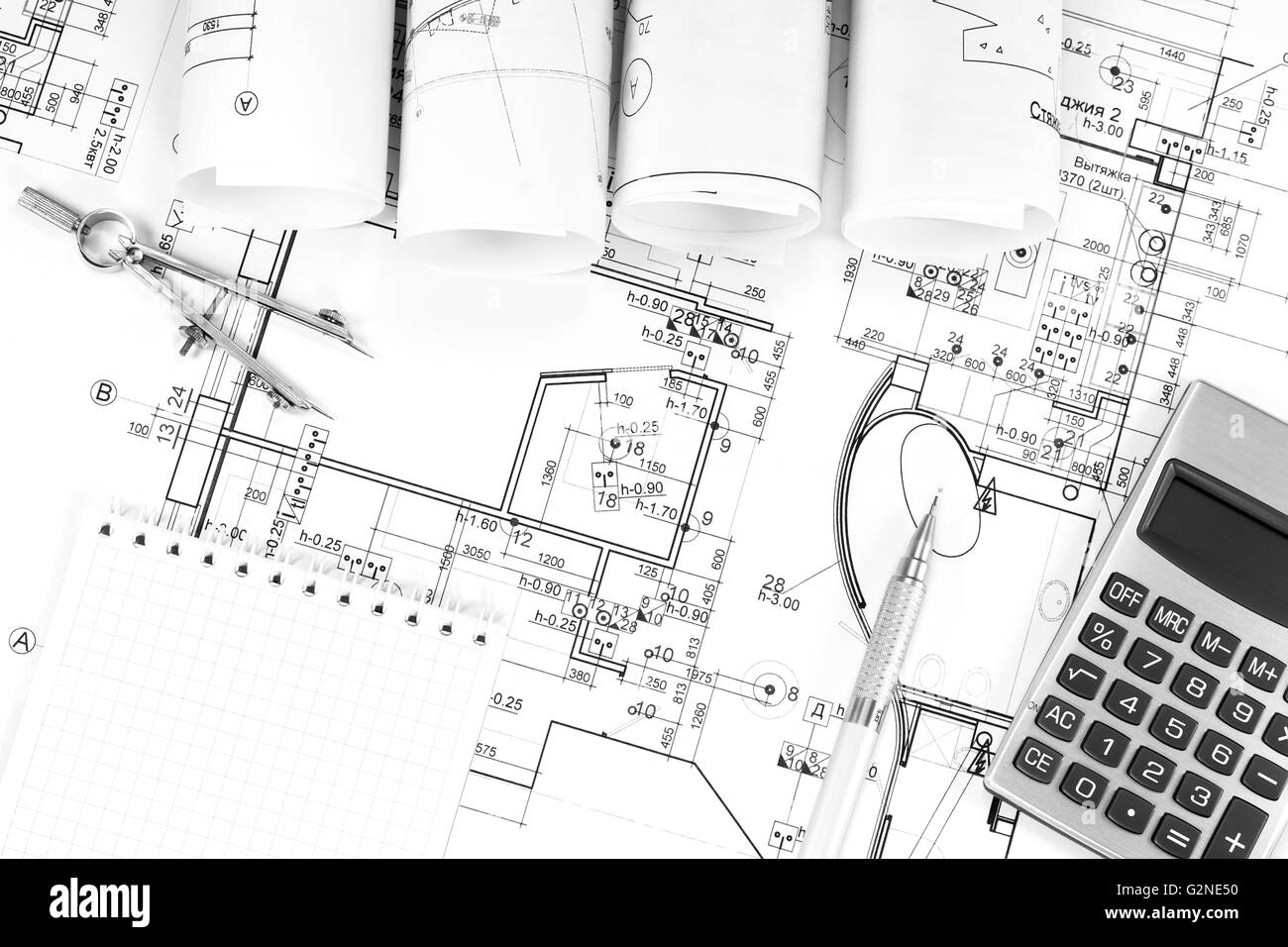 Architectural background with rolls of technical drawings and work ...