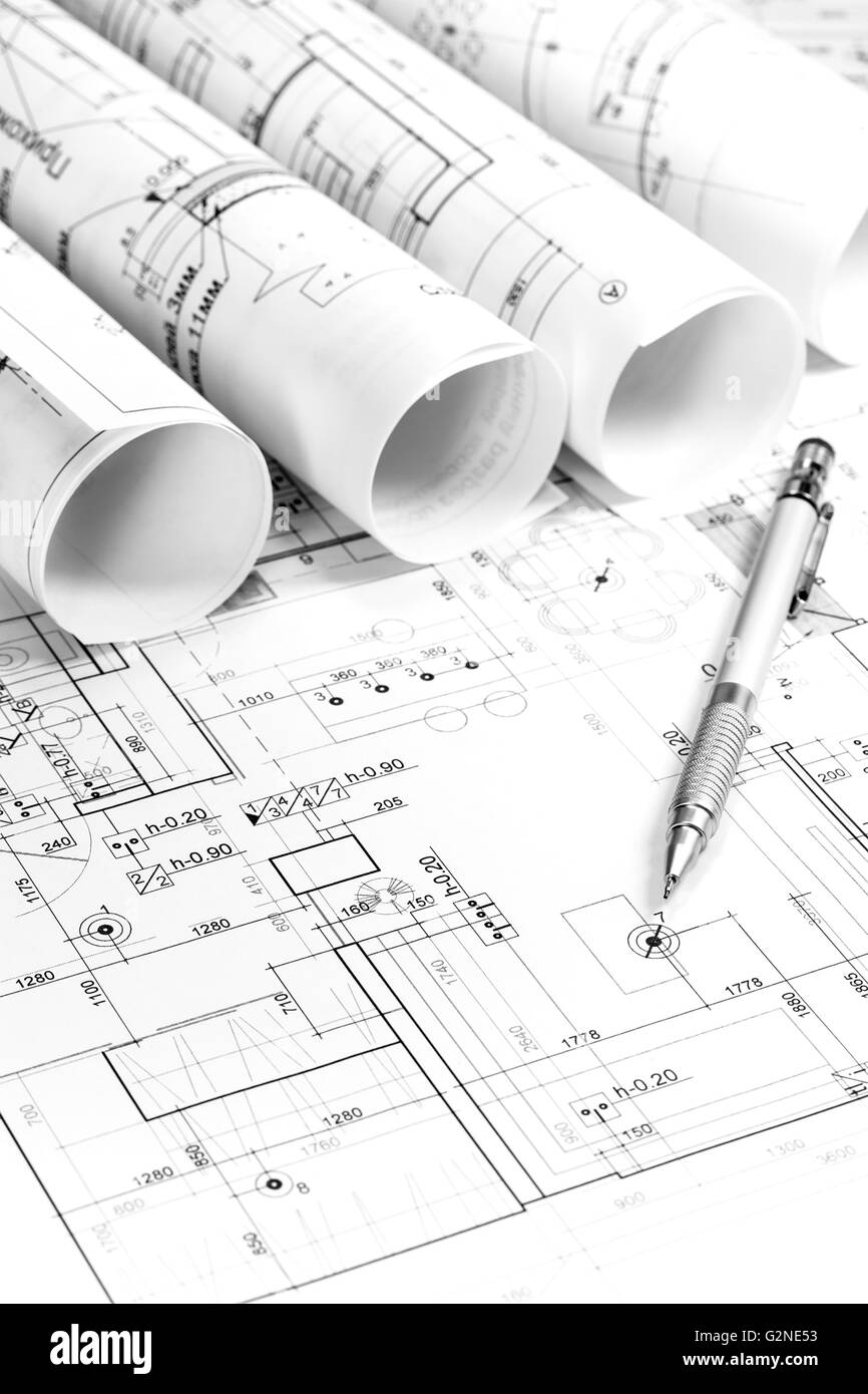 Architectural background with rolls of technical drawings and work ...