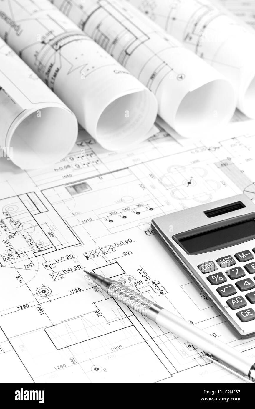 Architectural background with rolls of technical drawings and work ...