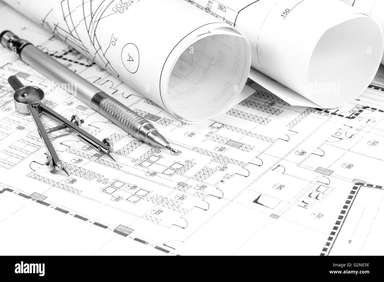 Architectural background with rolls of technical drawings and work ...