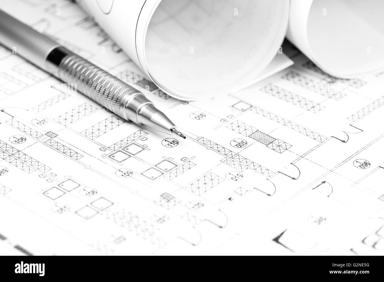 Architectural background with rolls of technical drawings and work ...