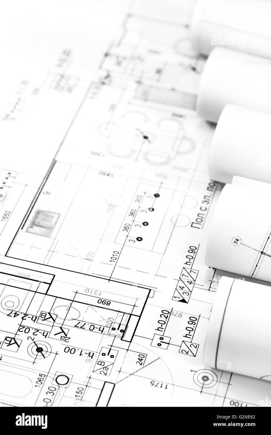 Architectural background with rolls of technical drawings and work ...