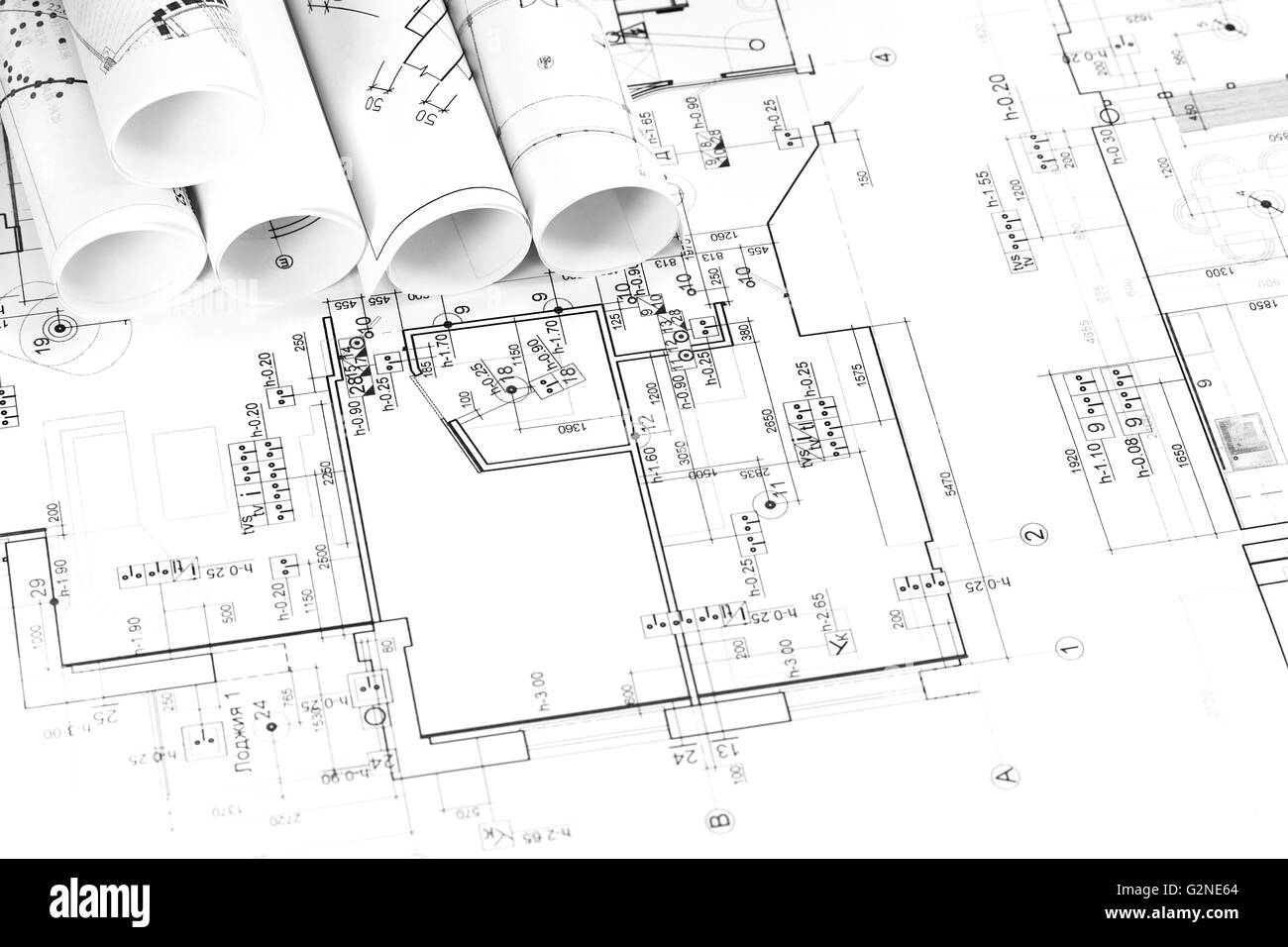 Architectural background with rolls of technical drawings and work ...