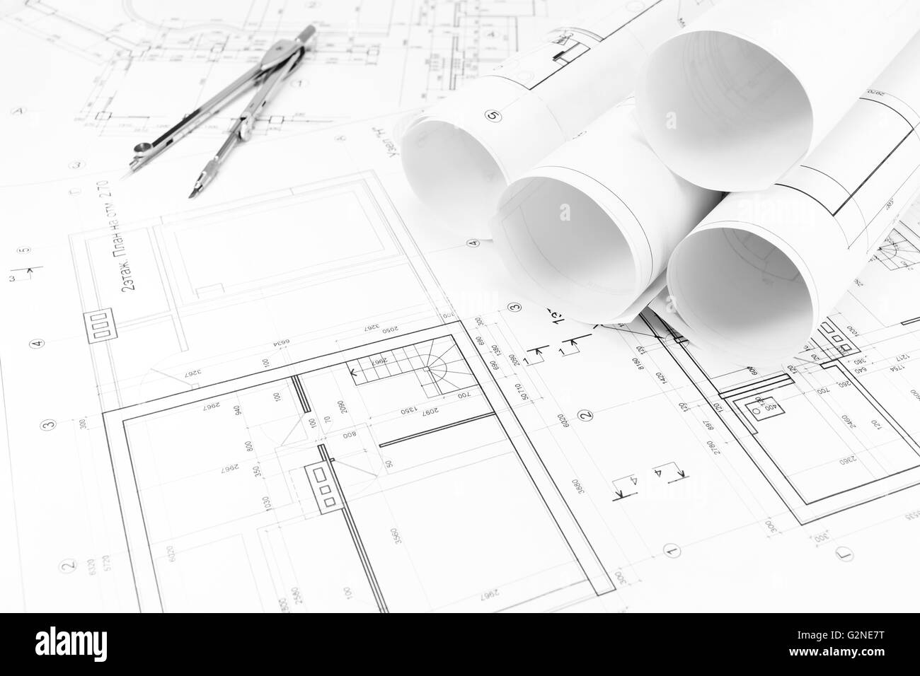 Architectural background with floor plans and rolls of technical ...