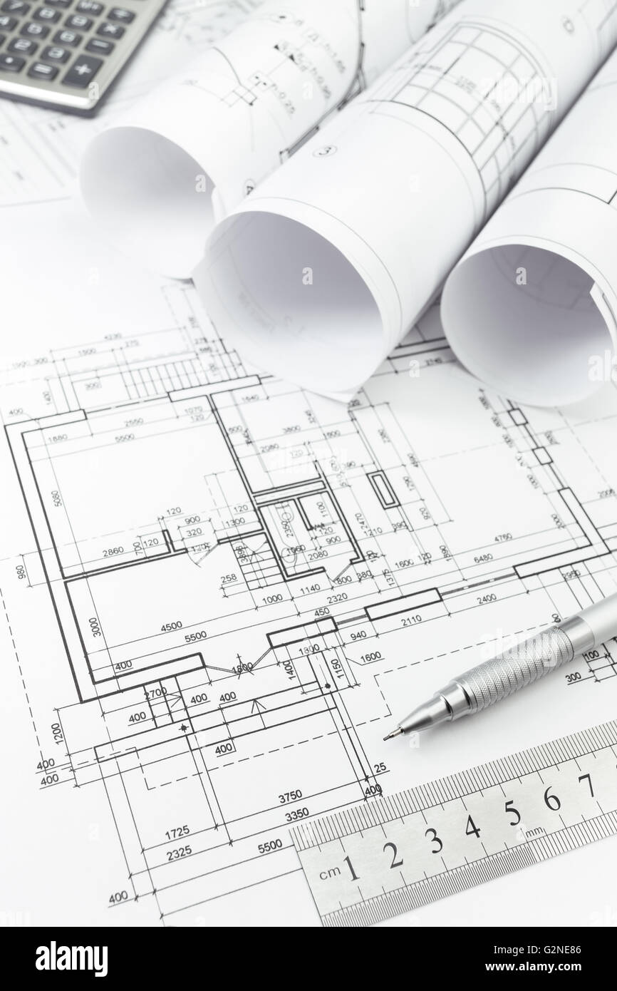 Architectural background with floor plans, rolls of technical drawings ...