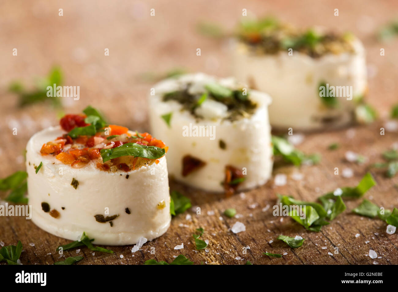 Delicious appetizers with cheese and various ingredients on wooden ...