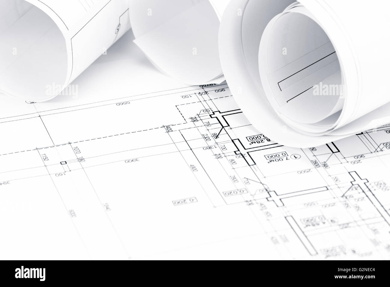 architectural background with floor plans and rolled technical drawings ...
