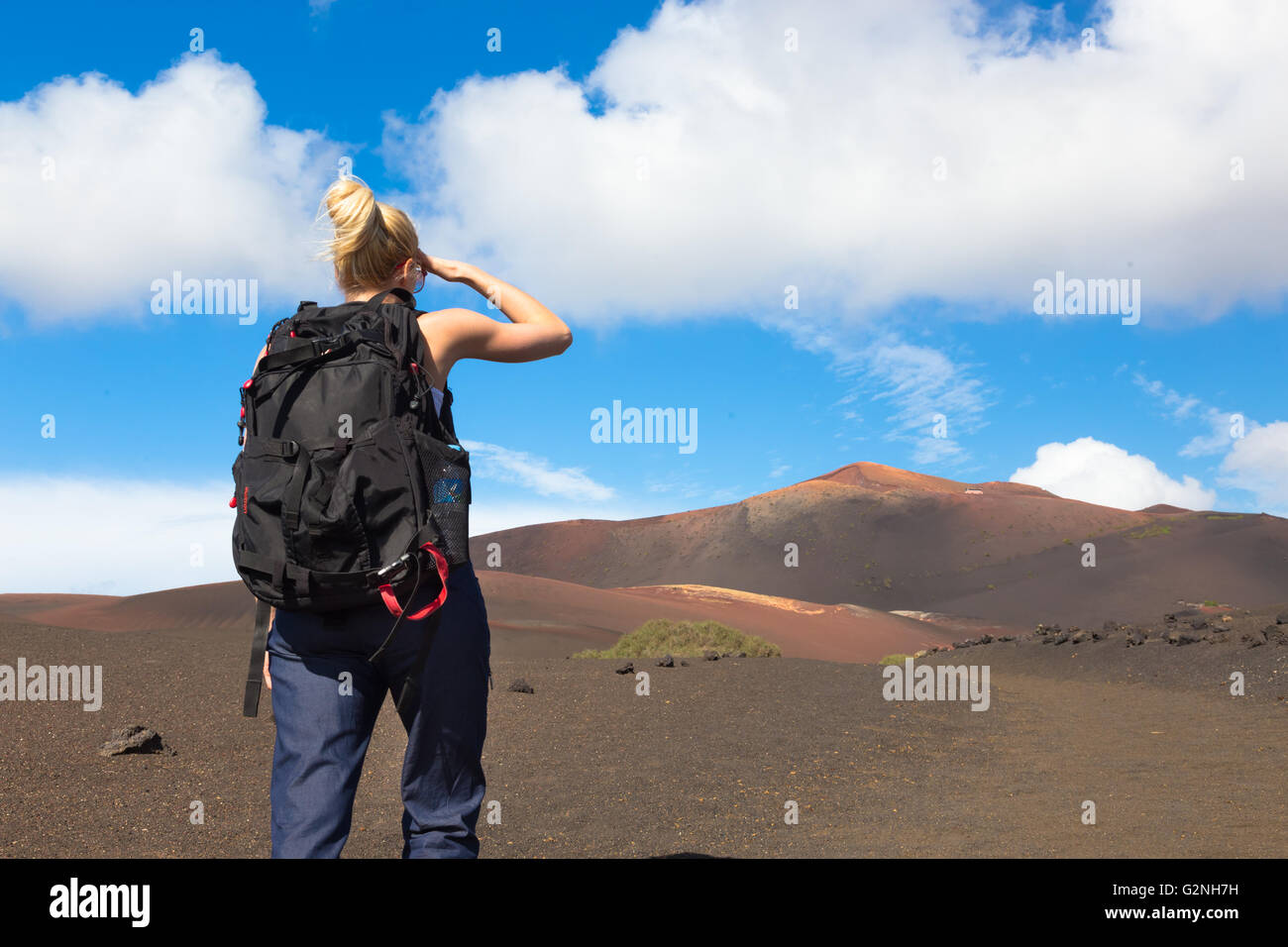 Woman tracking to top of mountain Stock Photo - Alamy