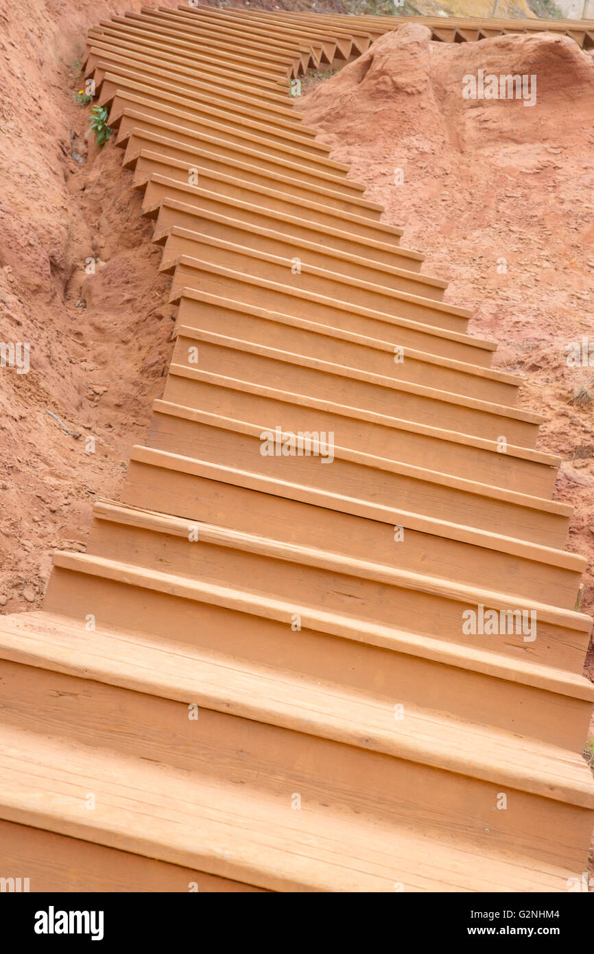 Wooden Curved Stairway on Clay Background Stock Photo - Alamy