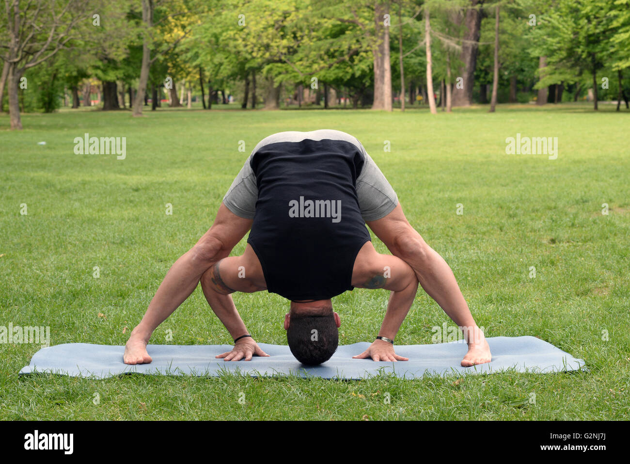 Man doing yoga Stock Photo - Alamy