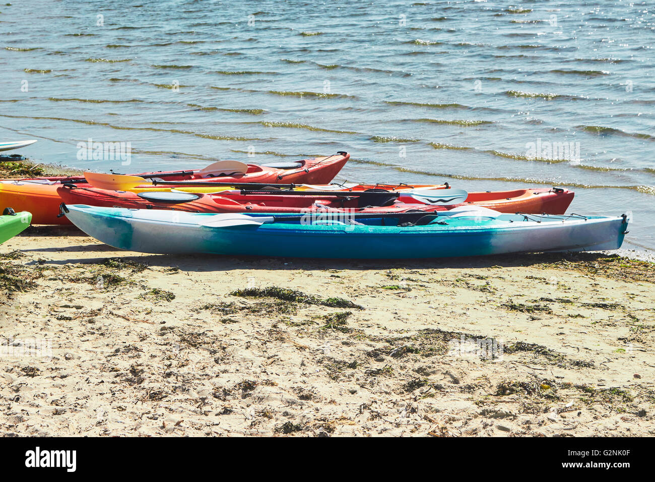Kayaks on the beach in different colors, sunny day at the sea Stock ...