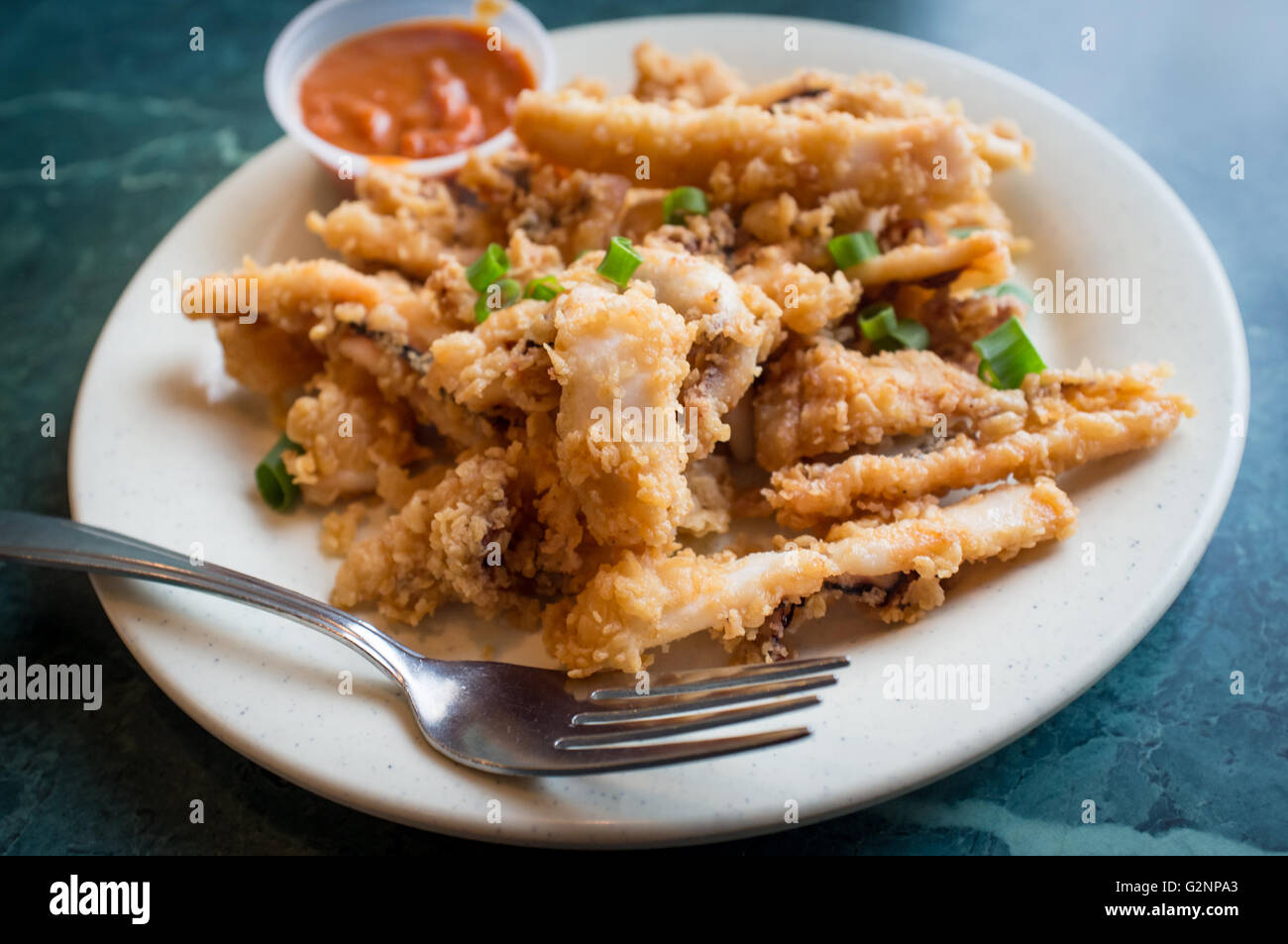 Plate of crispy calamari rings appetizer on green marble table Stock ...