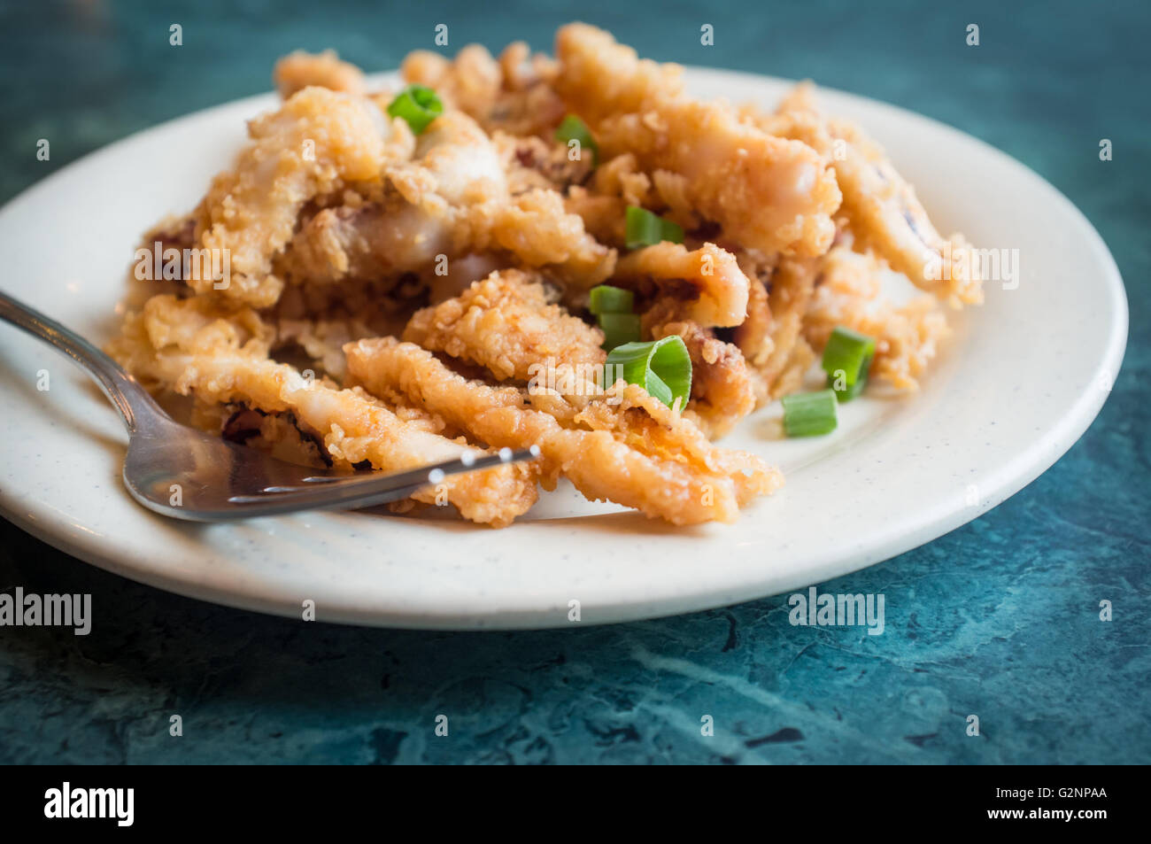 Plate of crispy calamari rings appetizer on green marble table Stock ...