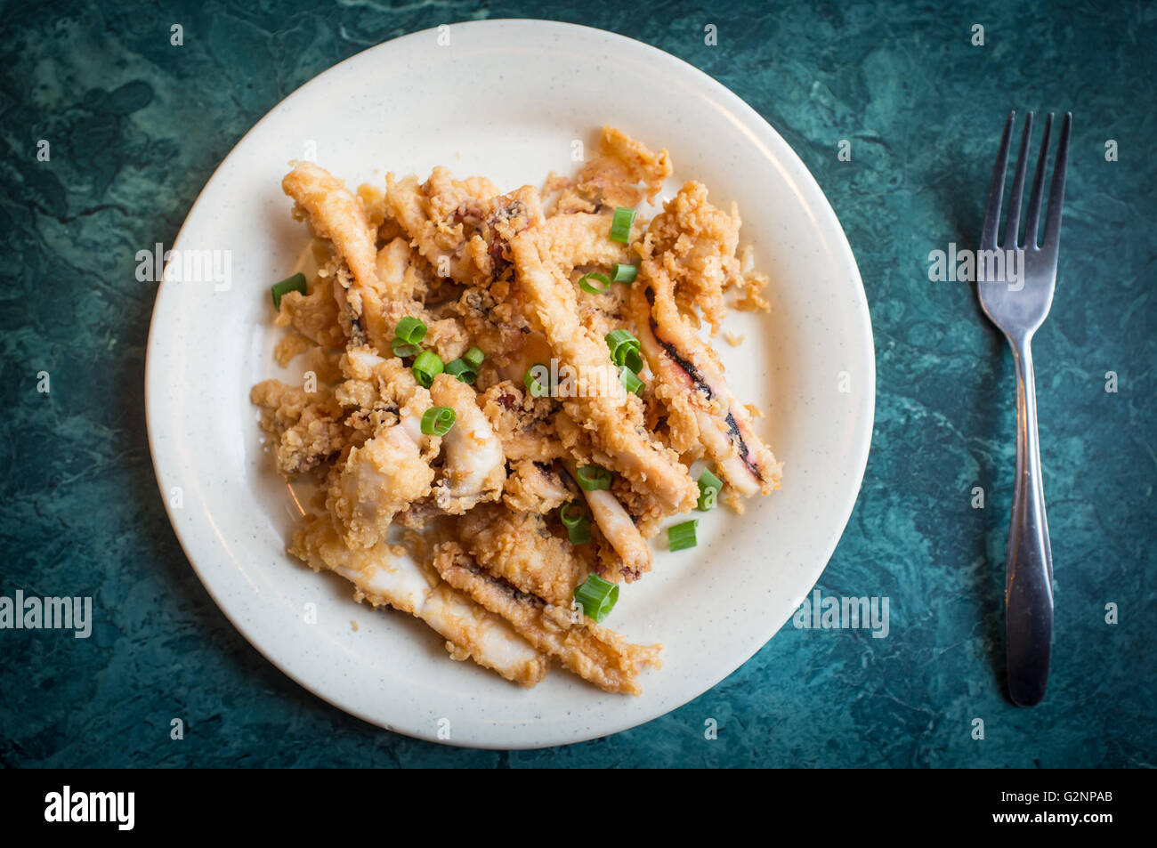 Plate of crispy calamari rings appetizer on green marble table Stock ...