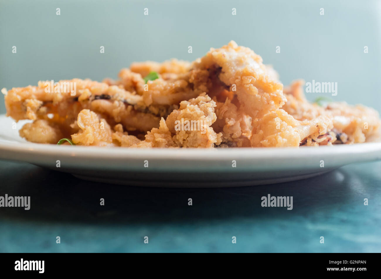 Plate of crispy calamari rings appetizer on green marble table Stock ...