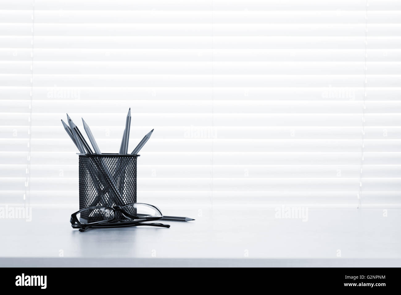 Office workplace with supplies on wood desk table in front of window ...