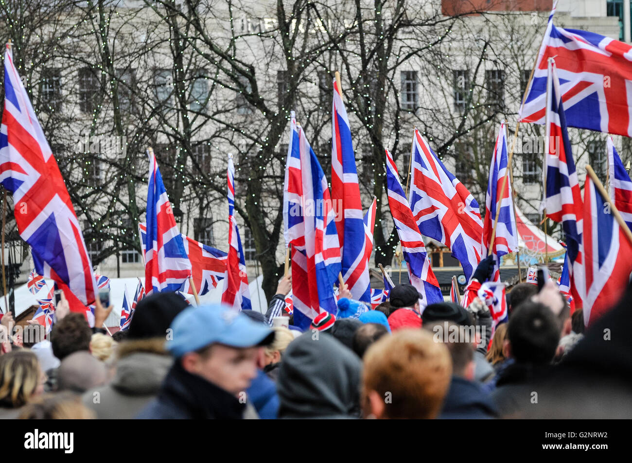 A crowd carrying many union flags as part of the Belfast "Fleg" flag ...