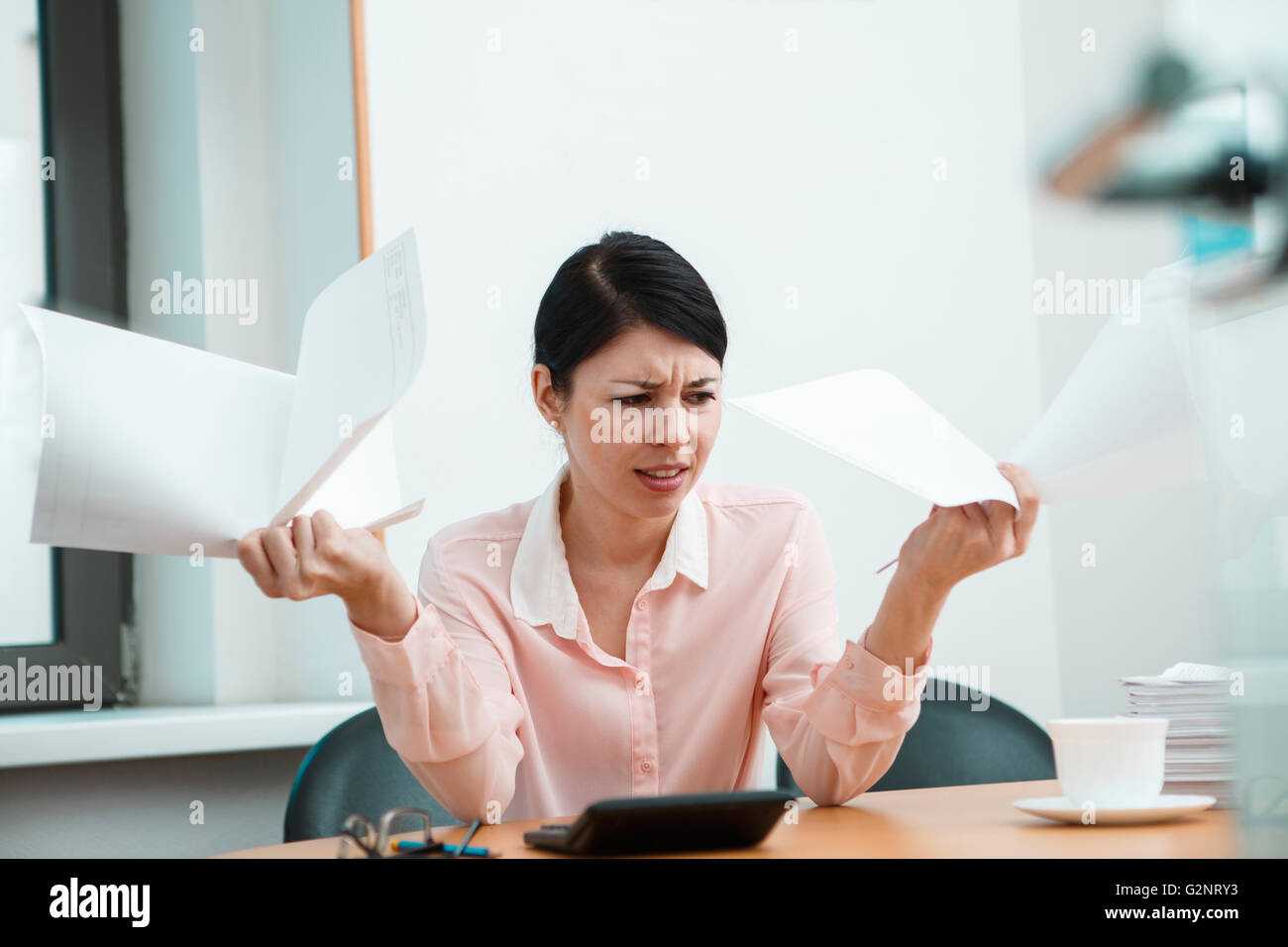 Woman in office with crumpled paper Stock Photo - Alamy