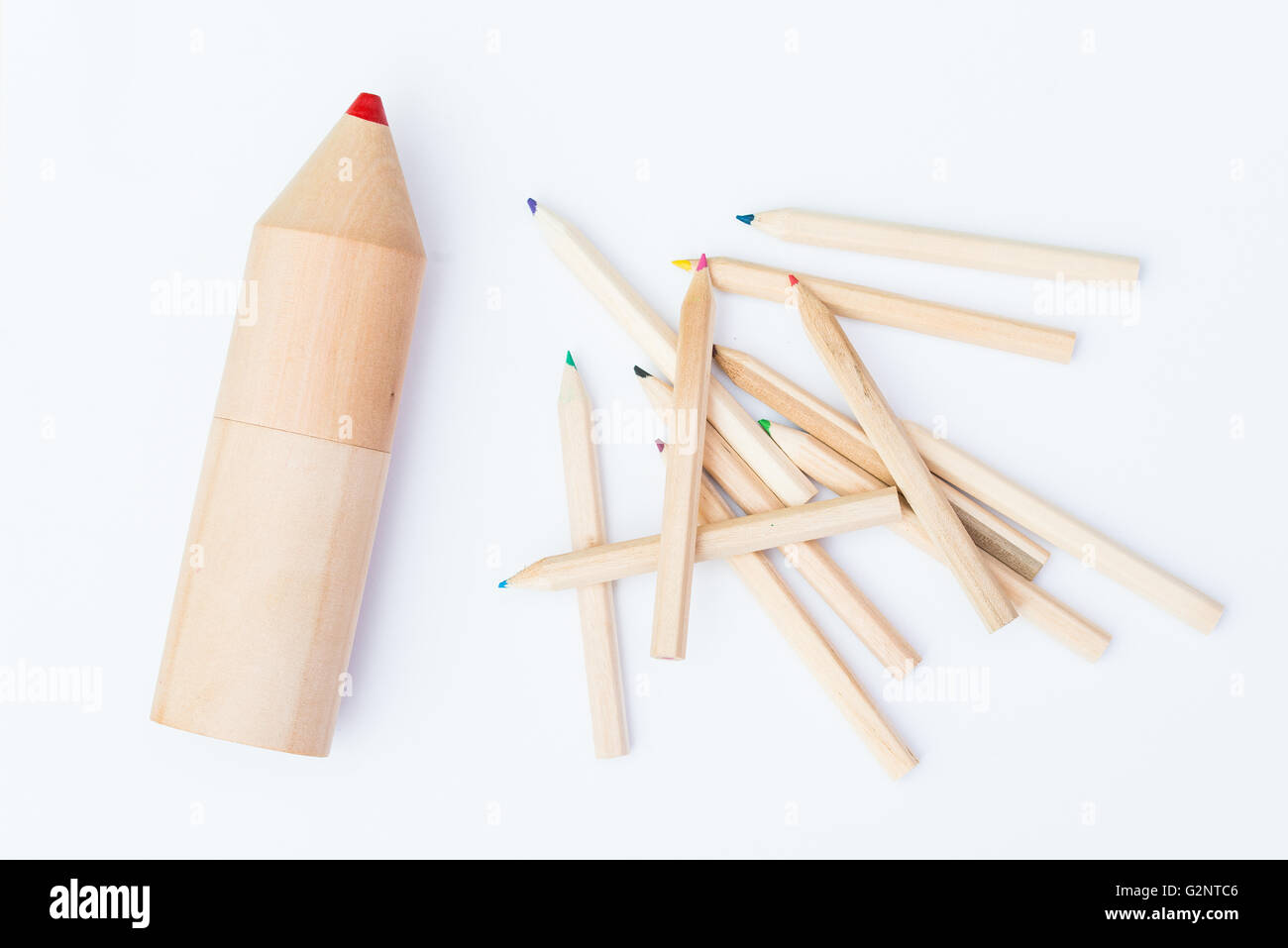 small pile of crayons and one huge crayon Stock Photo - Alamy