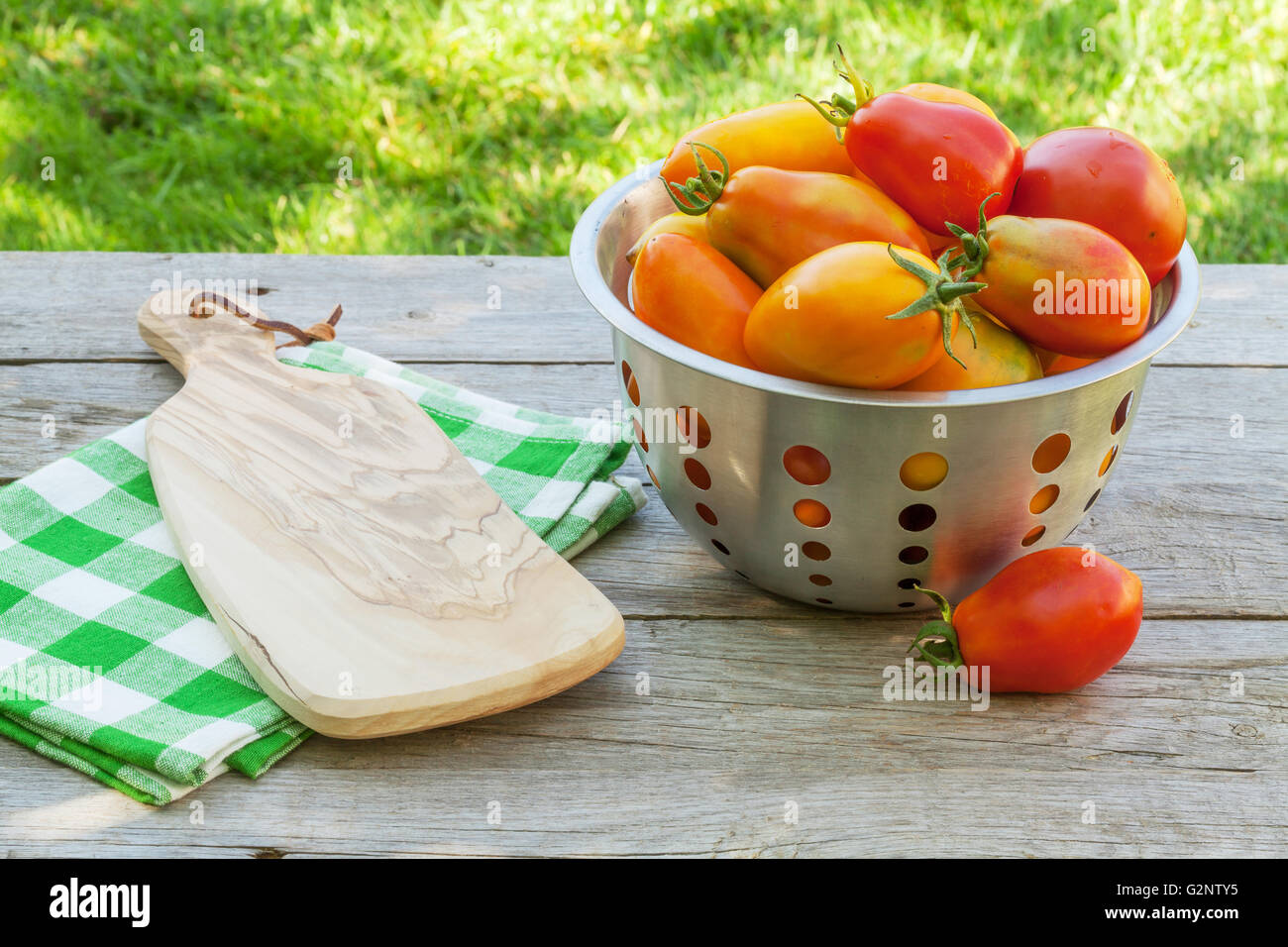 Fresh ripe tomatoes on garden table Stock Photo - Alamy