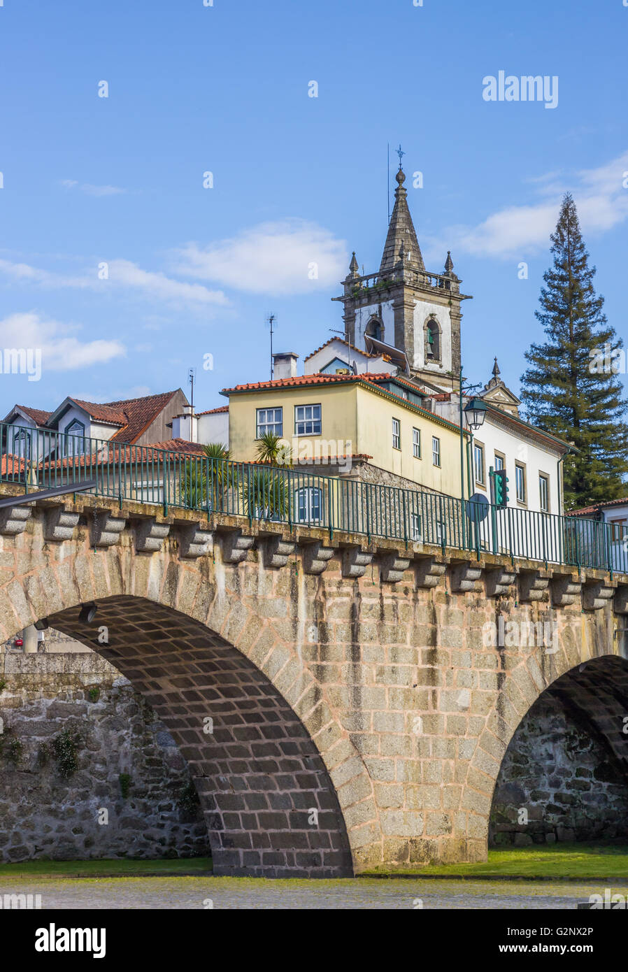 Roman bridge in front of a church in Ponte da Barca, Portugal Stock ...