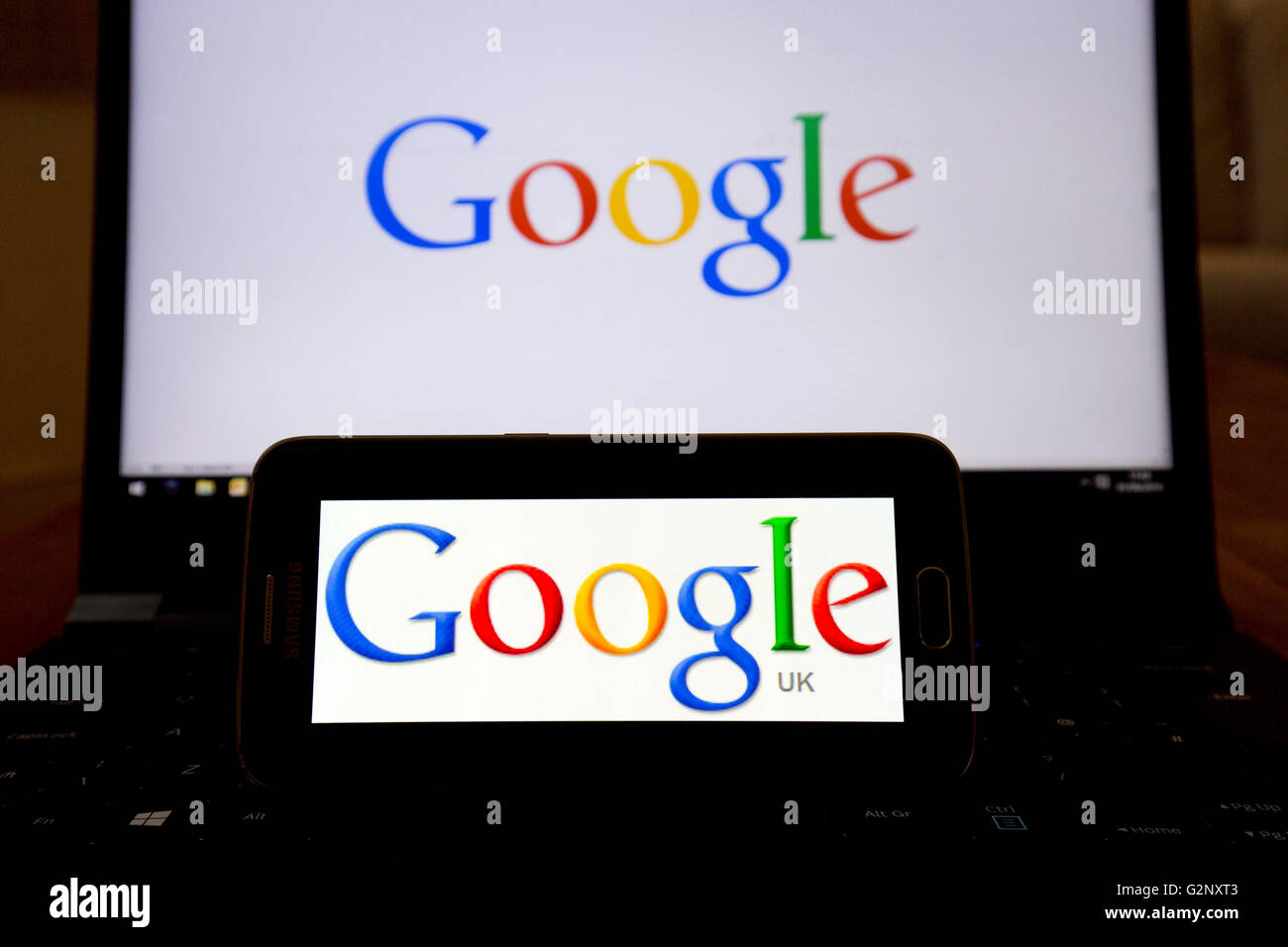 Google UK search engine logos are pictured on phone and laptop screens ...