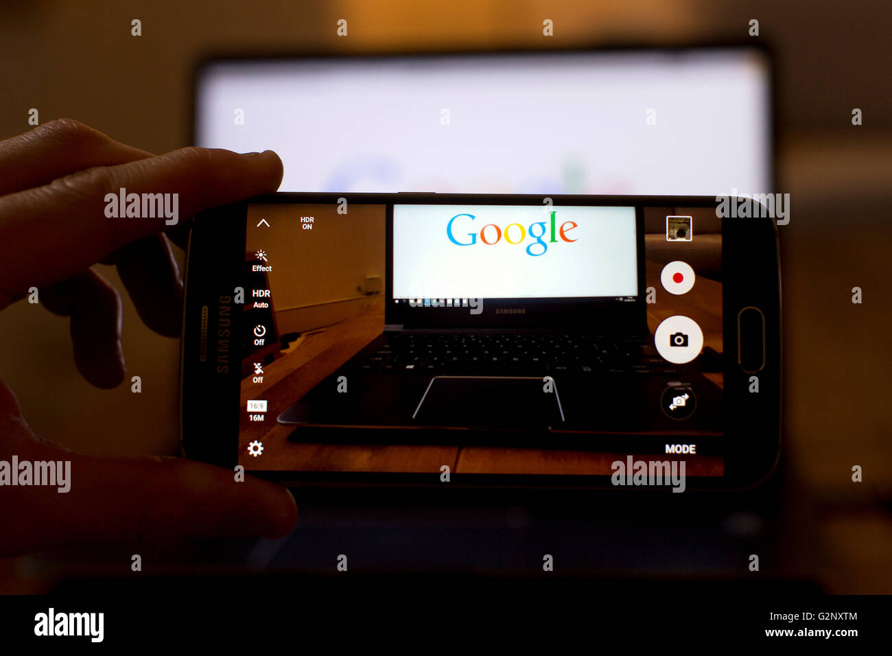 Google UK search engine logos are pictured on phone and laptop screens ...