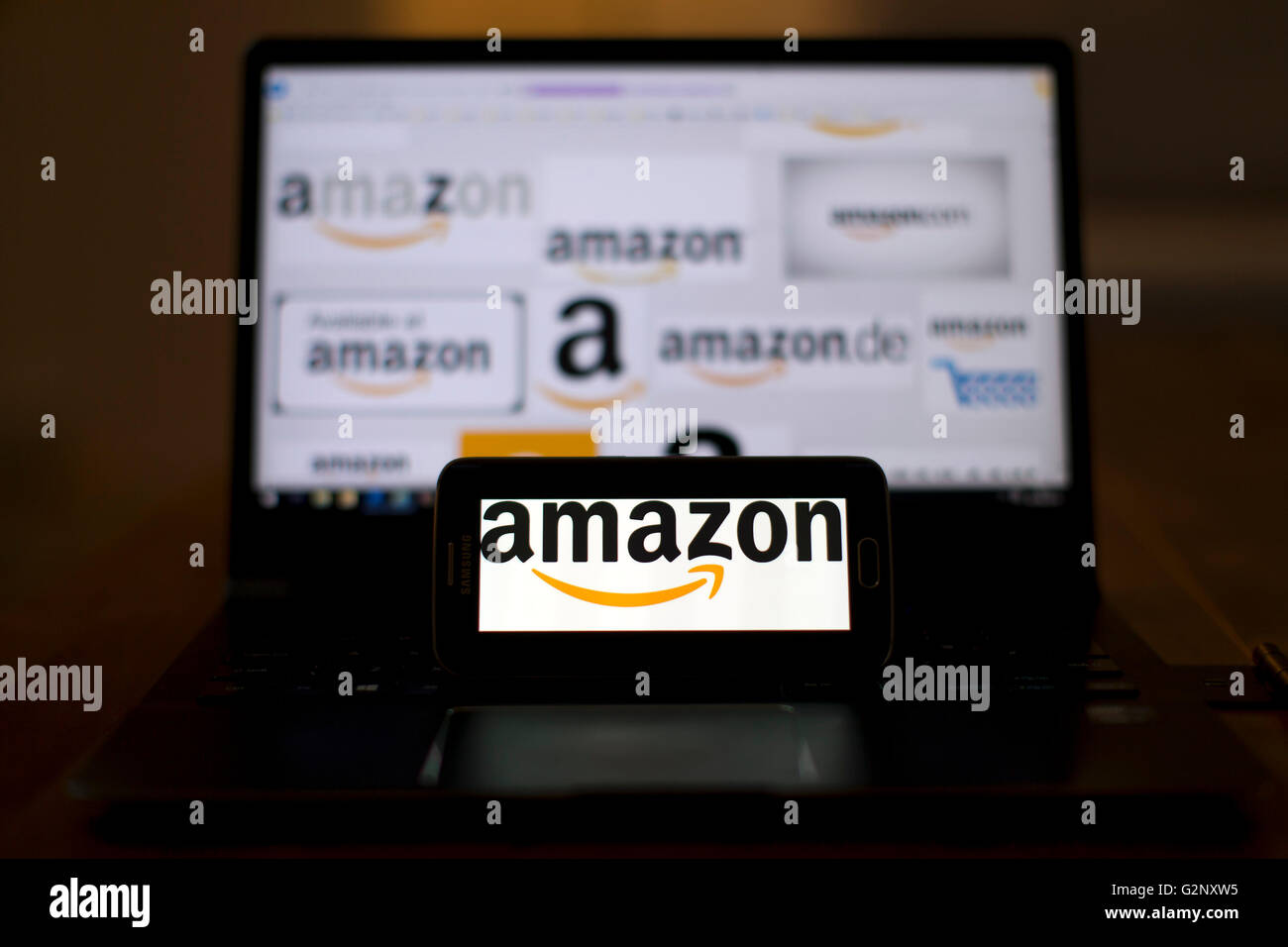 Amazon online retailer logos are pictured on phone and laptop screens ...