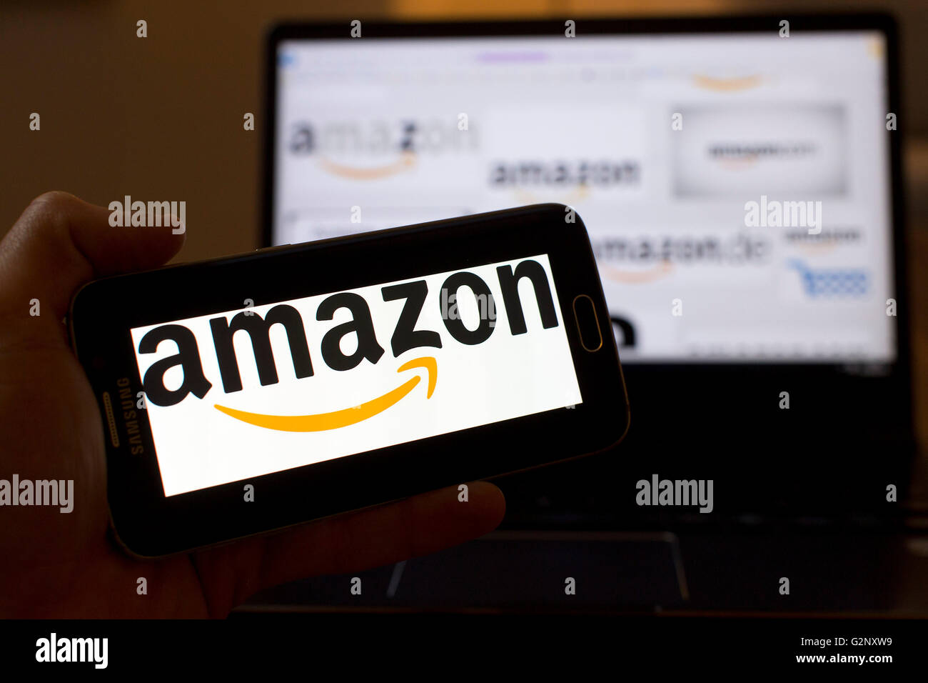 Amazon online retailer logos are pictured on phone and laptop screens ...
