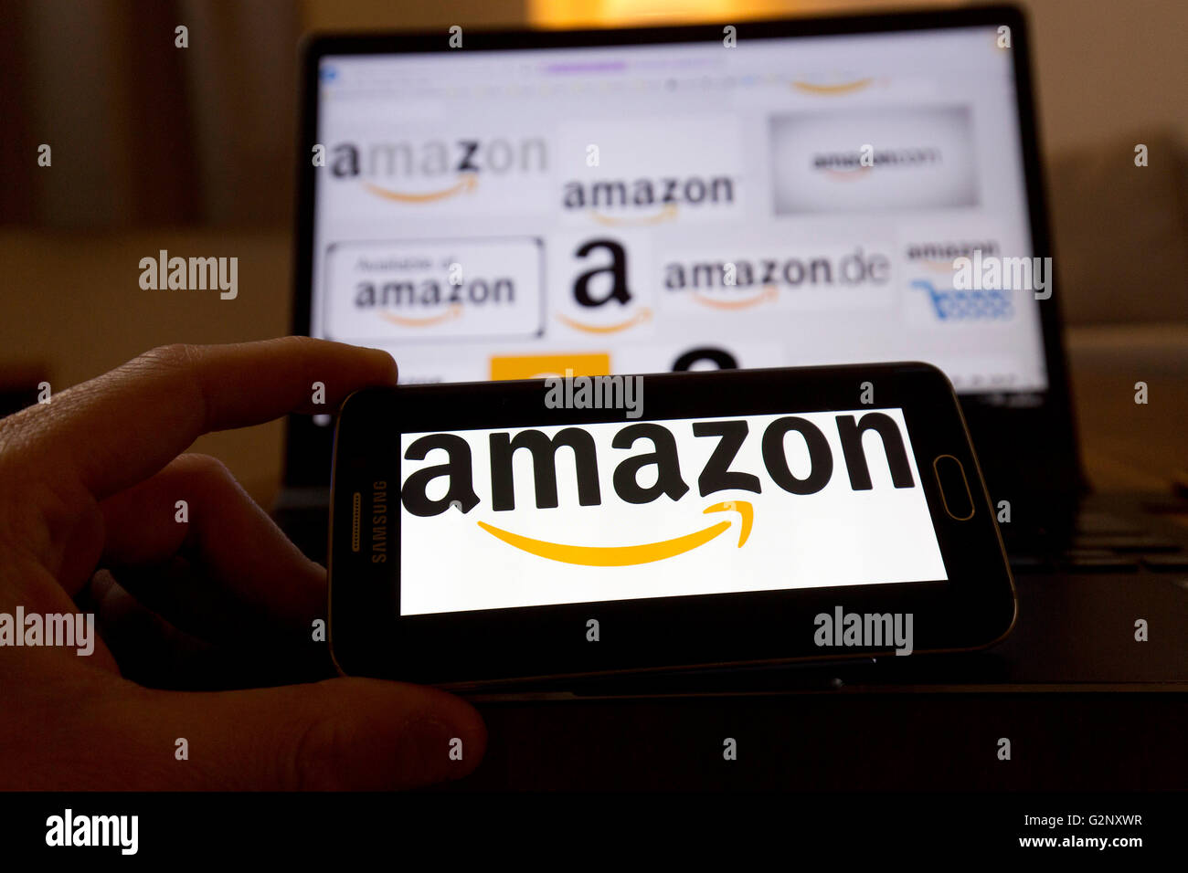 Amazon online retailer logos are pictured on phone and laptop screens ...