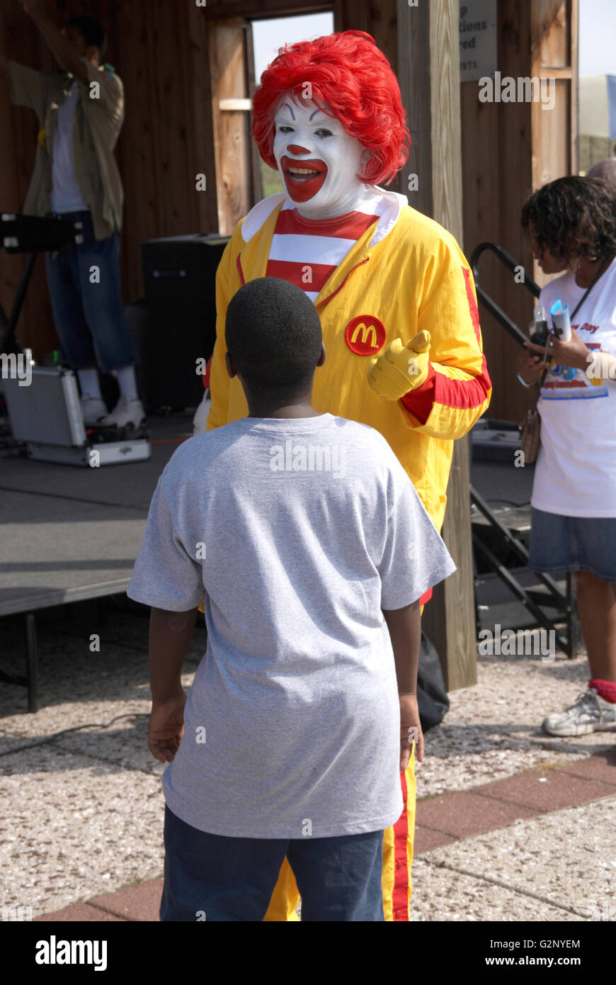 Ronald McDonald the clown talking to a young person at an event in ...