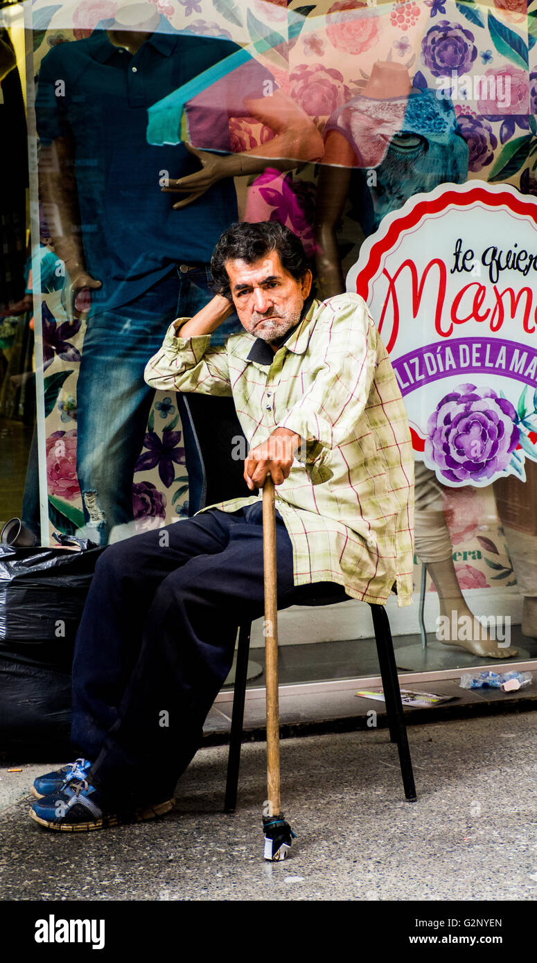 A man takes a break with his walking stick Stock Photo - Alamy