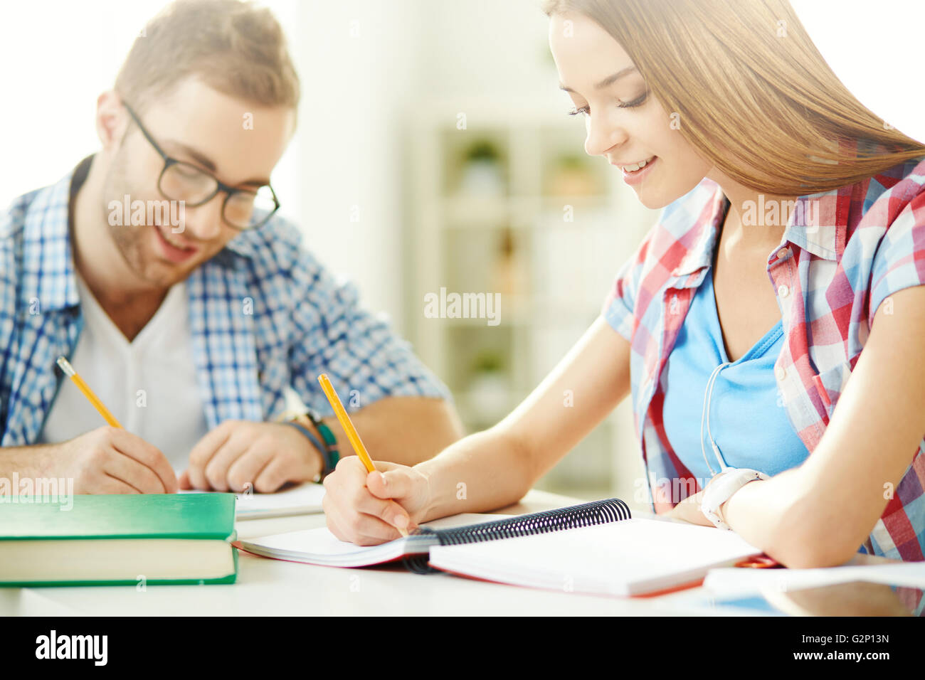 Teenage student making notes at lesson Stock Photo - Alamy