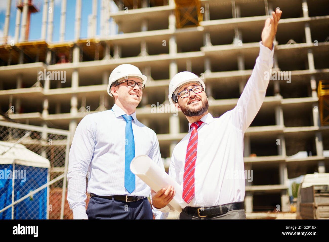 Builders looking at new construction outdoors Stock Photo - Alamy