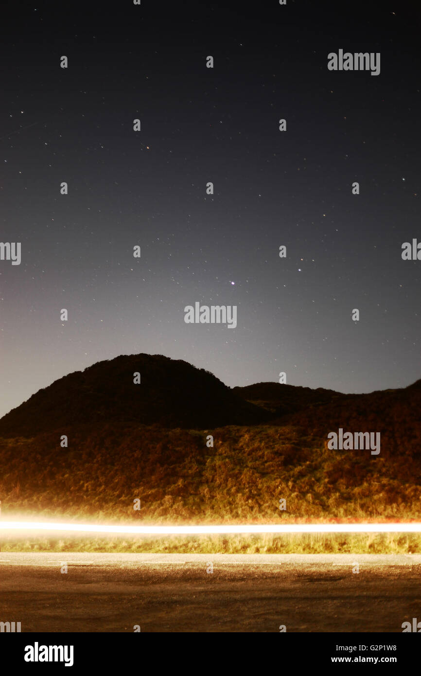 Car lights road under starlight Stock Photo - Alamy