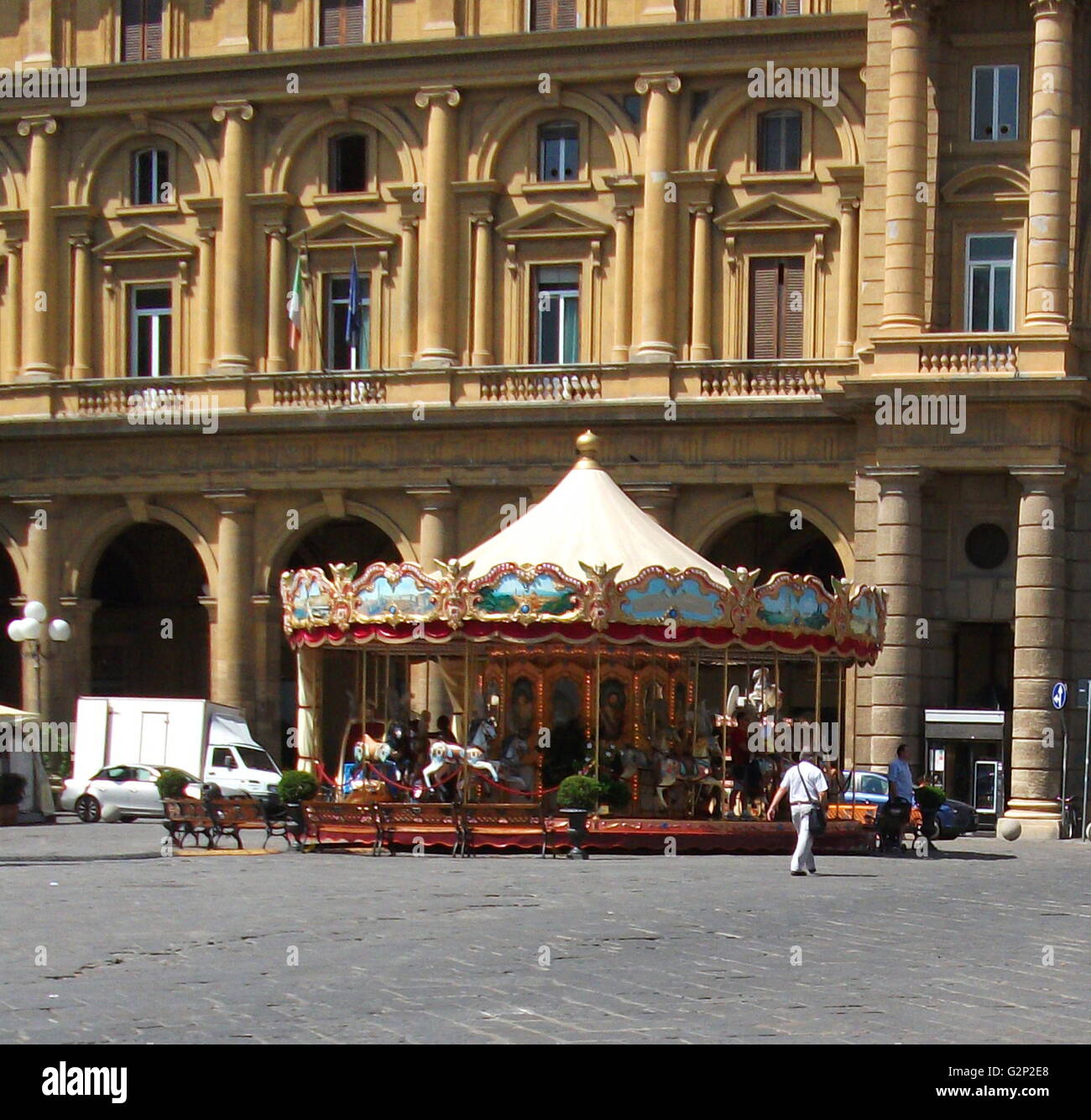An antique carnival carousel in the middle of a plaza in Florence ...