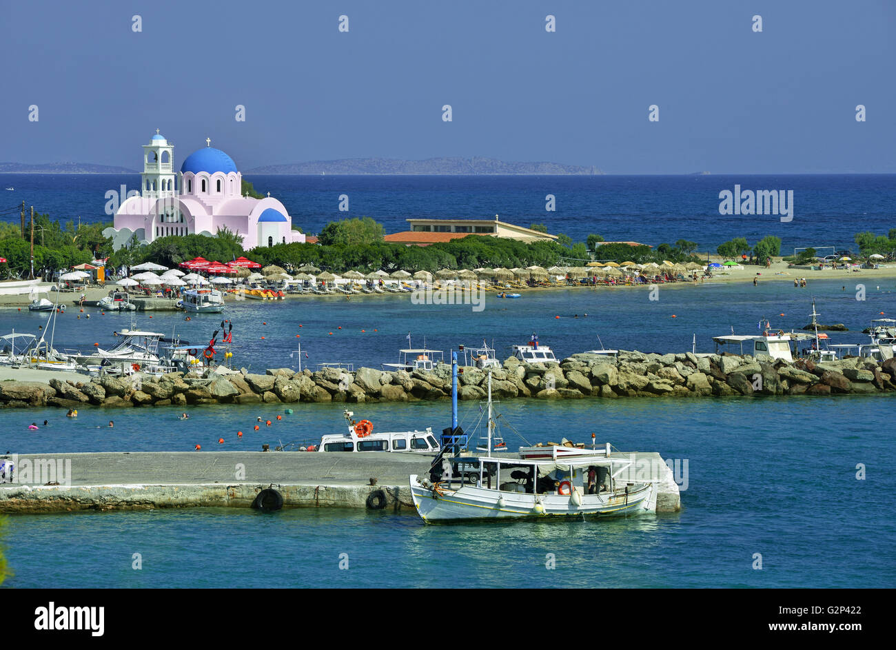 close view to Skala's port, the beach and the church, on Agistri island ...