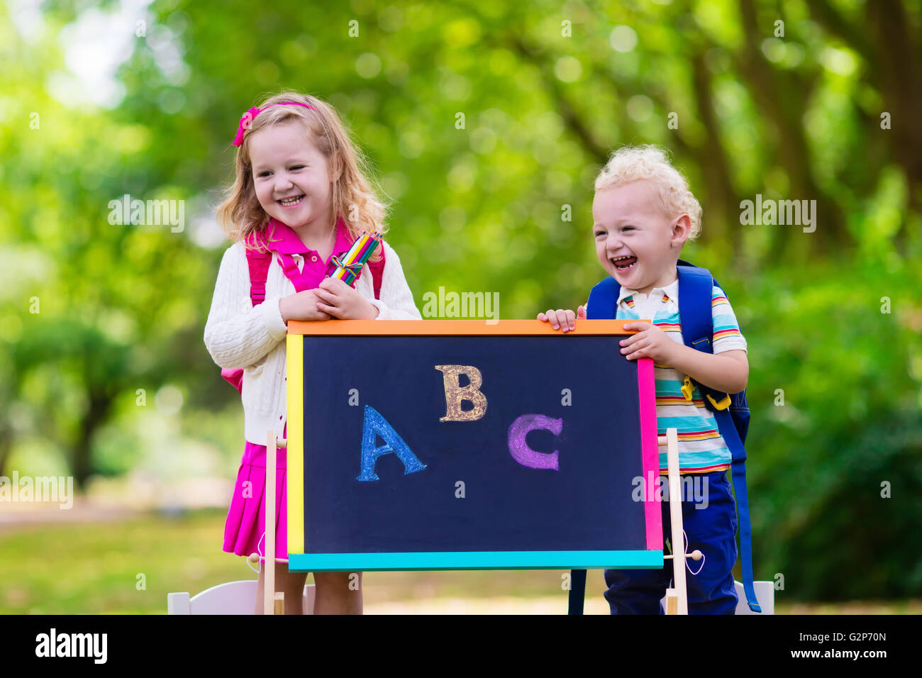 Children happy to be back to school. Preschooler girl and boy with ...