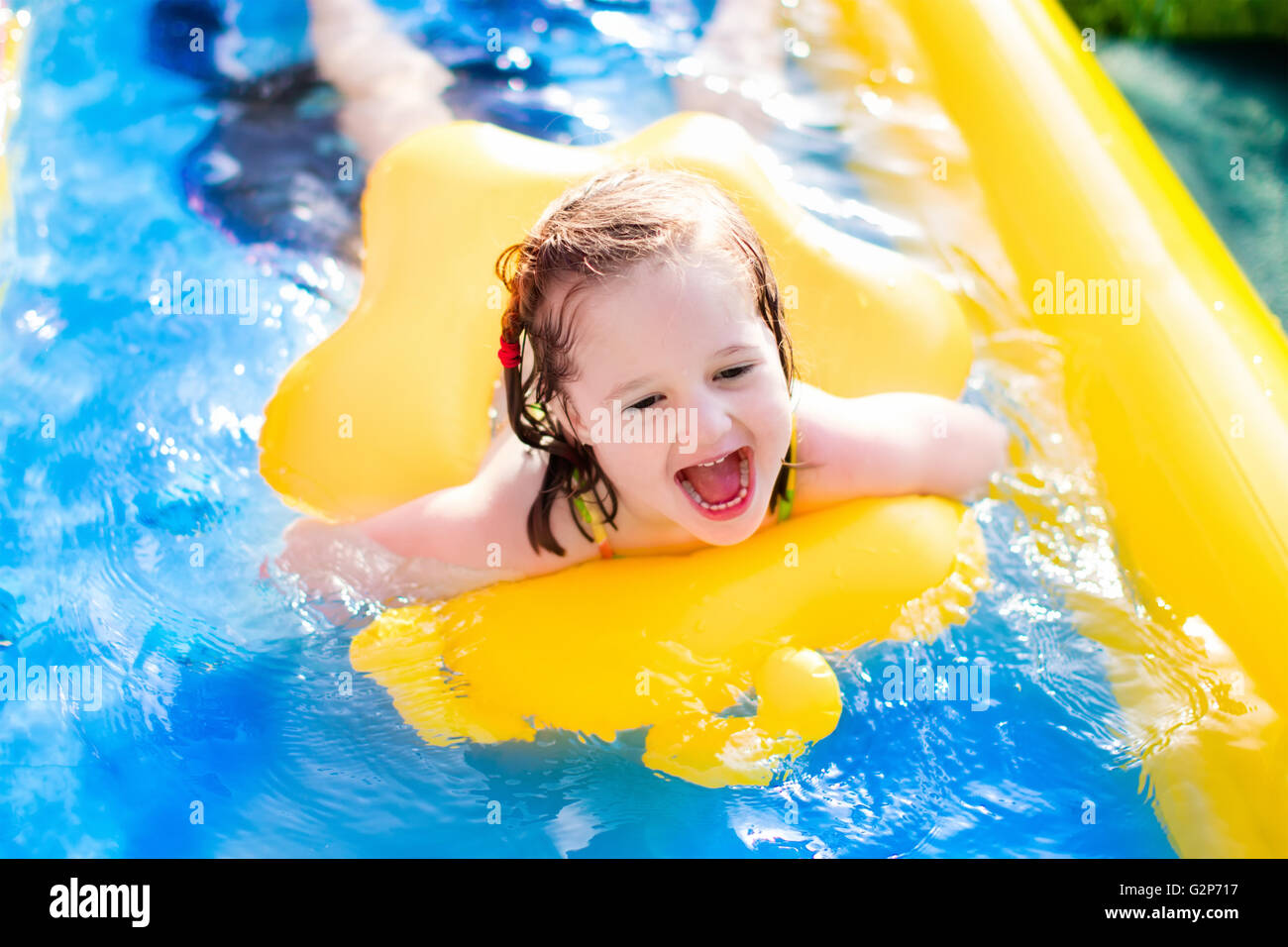 Children playing in inflatable baby pool. Kids swim and splash in ...