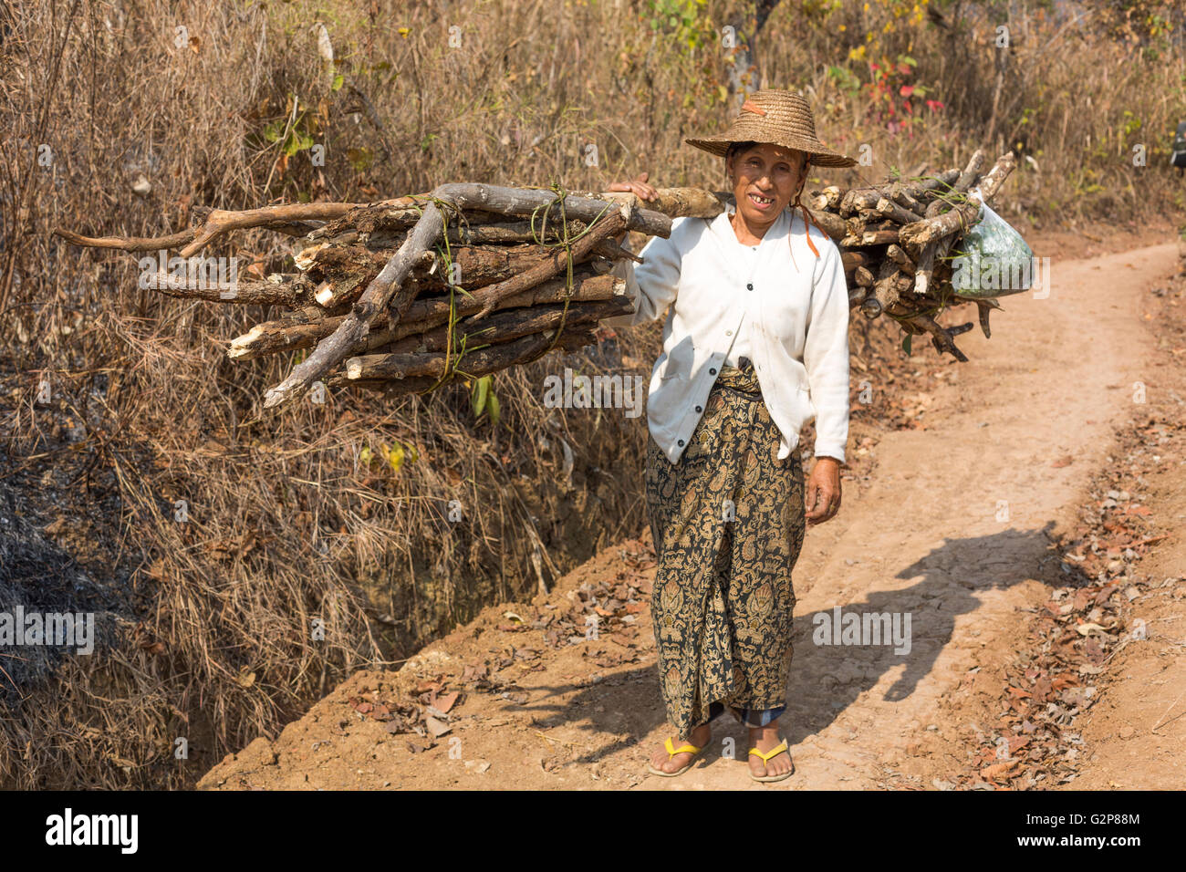 Old woman carrying wood hi-res stock photography and images - Alamy