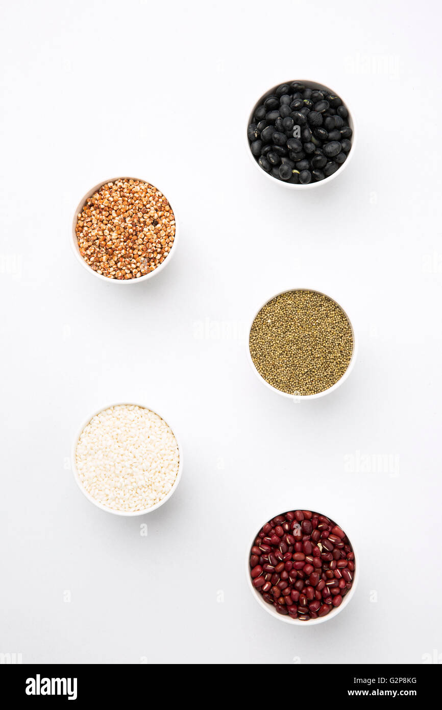 Different types of grains in bowls, from high angle view, isolated on ...