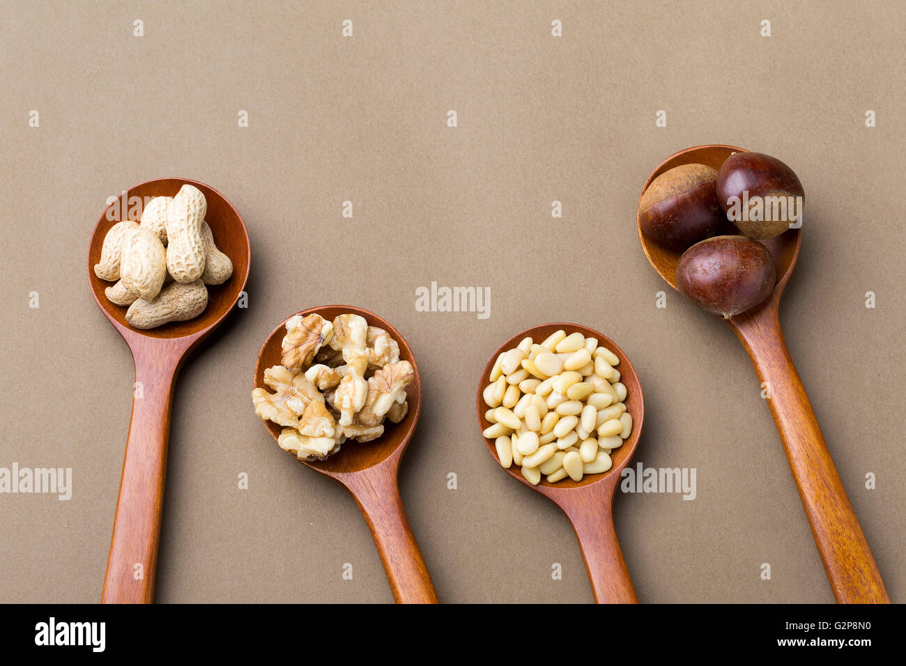 Different types of nuts on wooden ladles Stock Photo - Alamy
