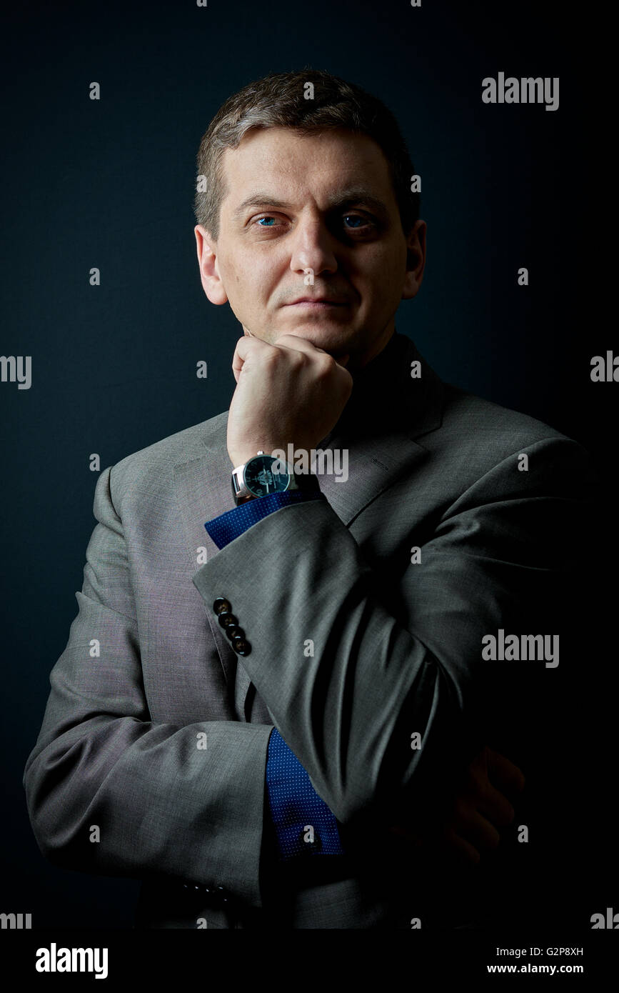 Low-key portrait of man in gray suite Stock Photo - Alamy
