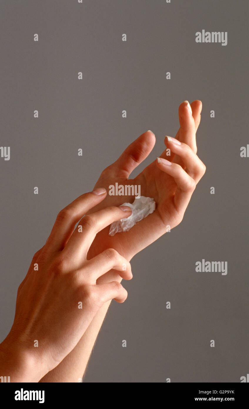 Hand cream being applied to a girls hand Stock Photo - Alamy