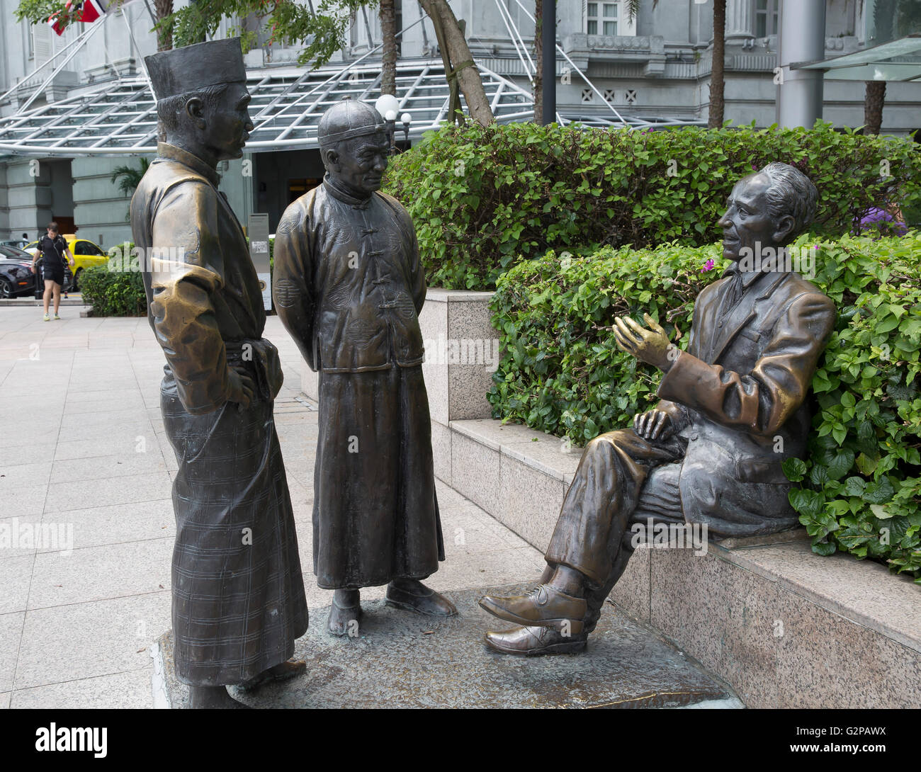Bronze Statue of two men standing and one sitting talking to each other ...