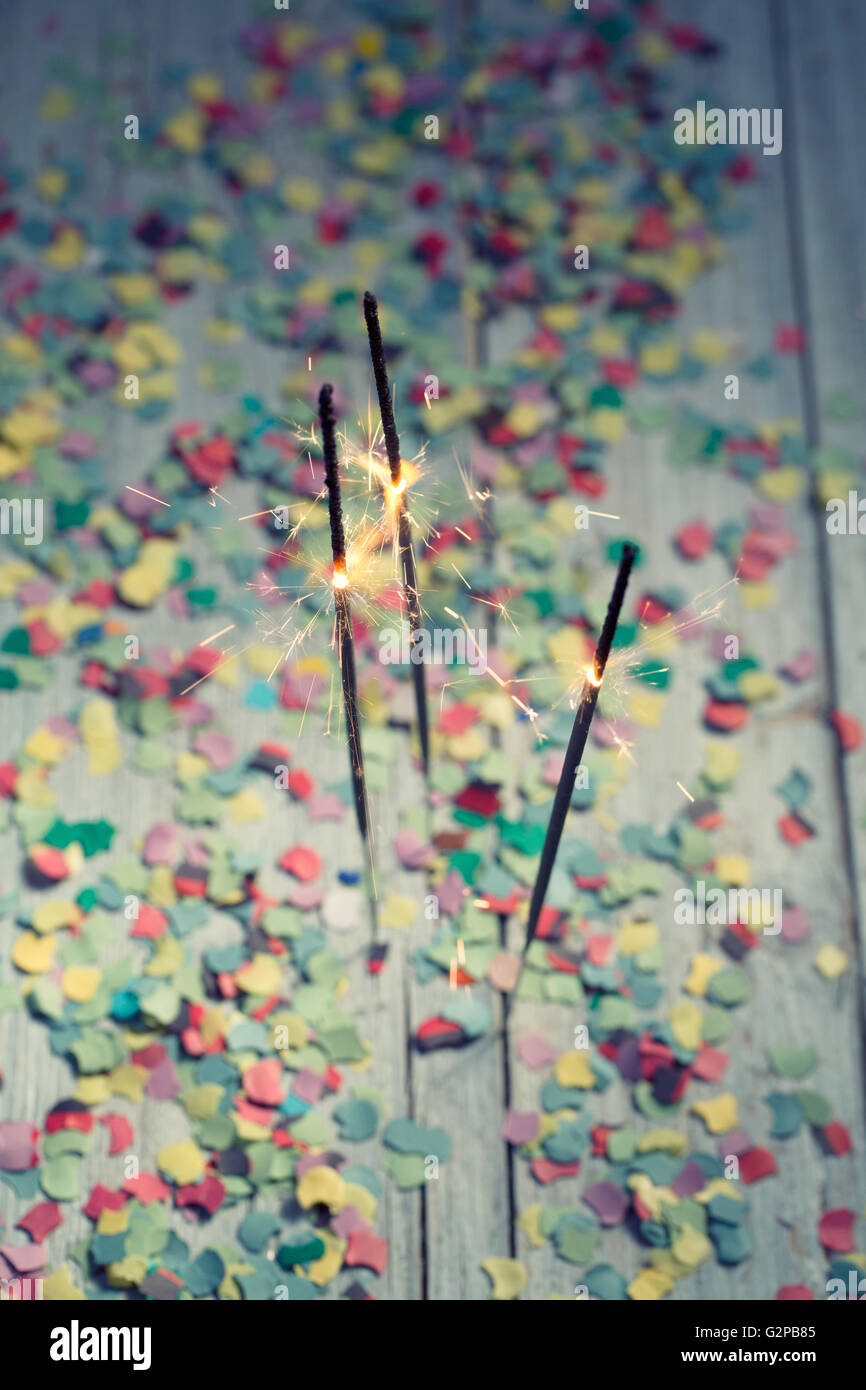 Burning Sparklers with colorful Confetti on wooden Table at a Party ...