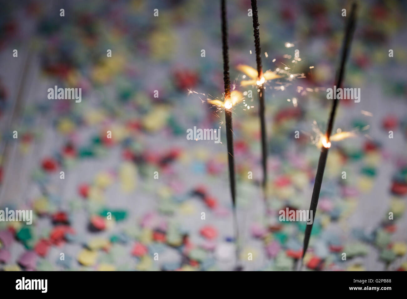 Burning Sparklers with colorful Confetti on wooden Table at a Party ...